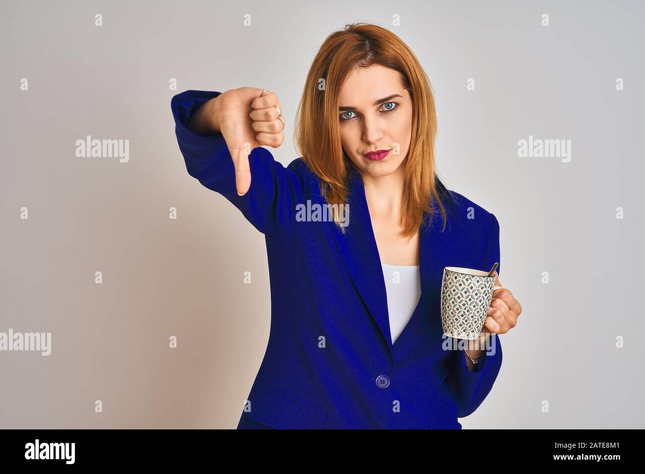 Redhead caucasian business woman drinking a cup of coffee over isolated ...