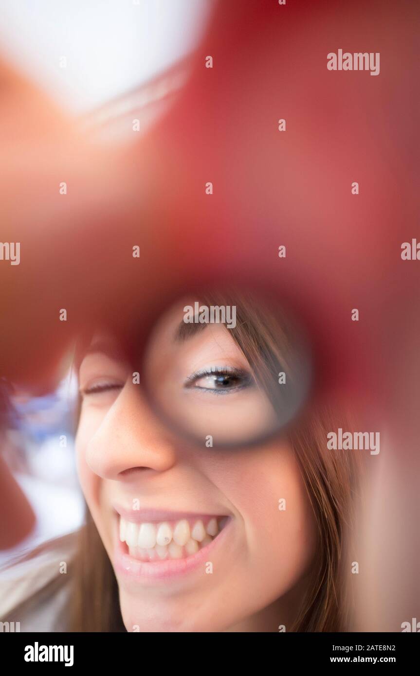 amused girl looks through the stretched ear lobe Stock Photo - Alamy