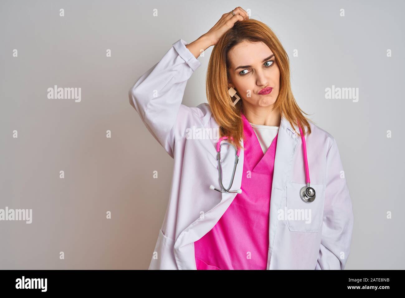 Redhead caucasian doctor woman wearing pink stethoscope over isolated ...