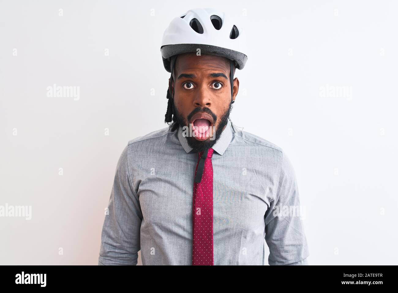African american businessman with braids wearing bike helmet over isolated white background ...