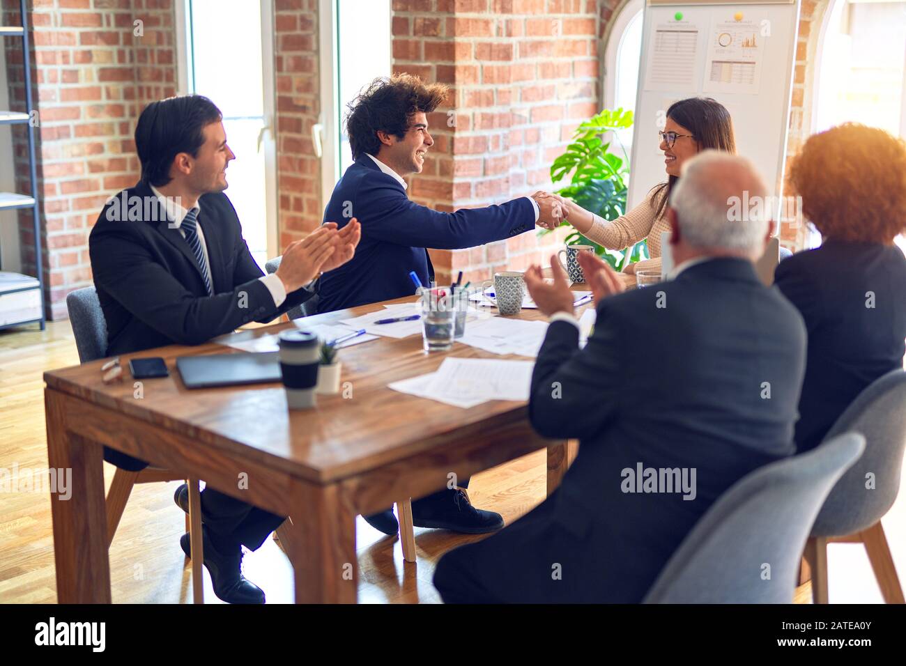 Group of business workers smiling happy and confident in a meeting ...