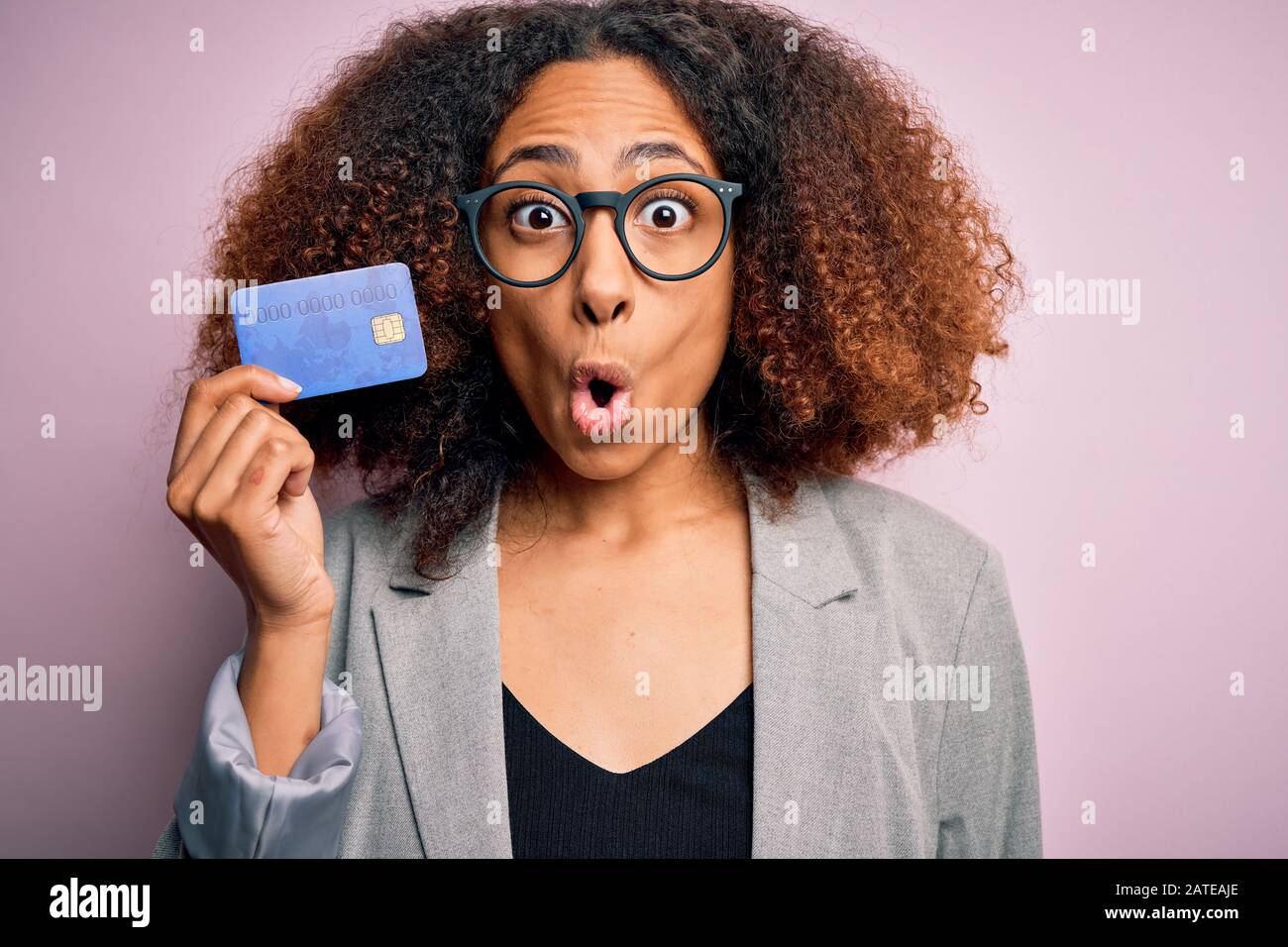 Young african american businesswoman with afro hair holding credit card ...