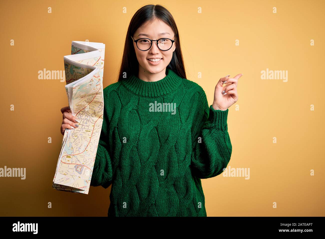 Young asian turist woman looking at city tourist map on a trip over ...
