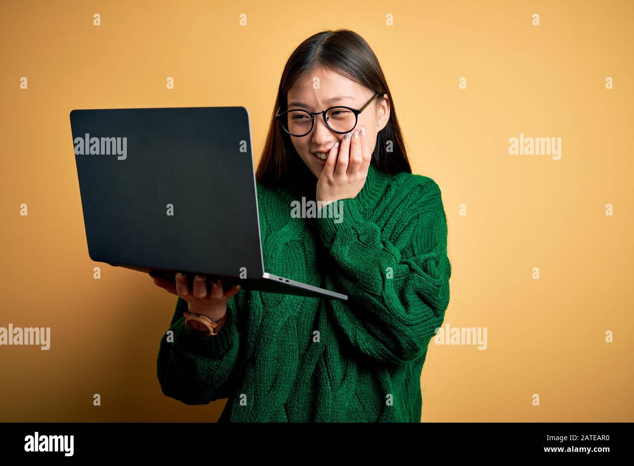 Young asian business woman wearing glasses and working using computer ...