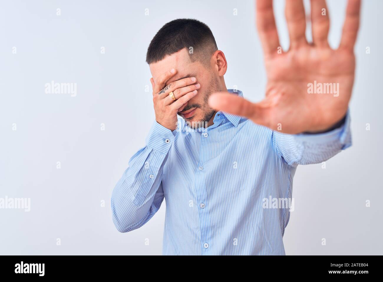 Young handsome business man standing over isolated background covering ...