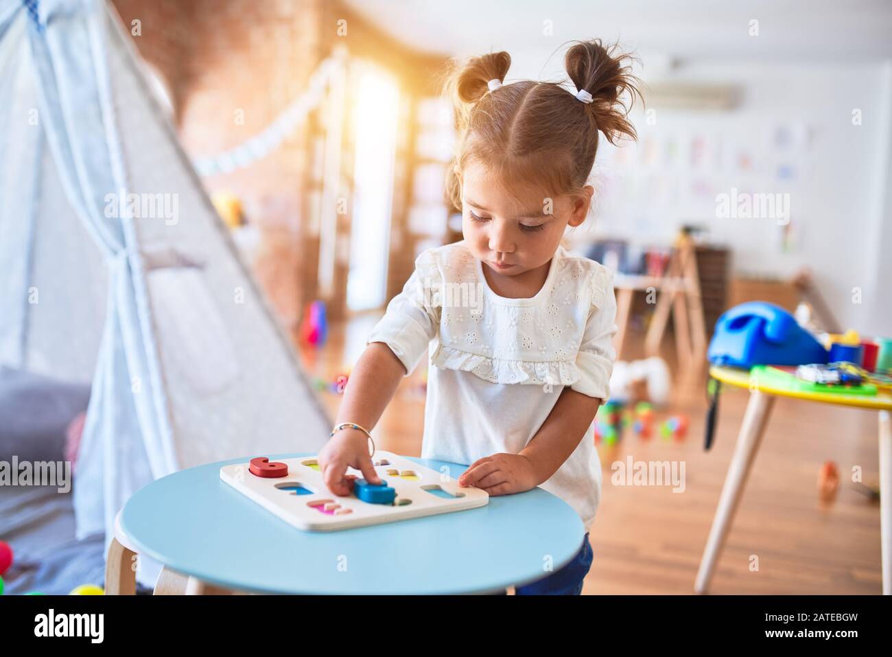 Young beautiful toddler learning mathematics playing with maths game at ...