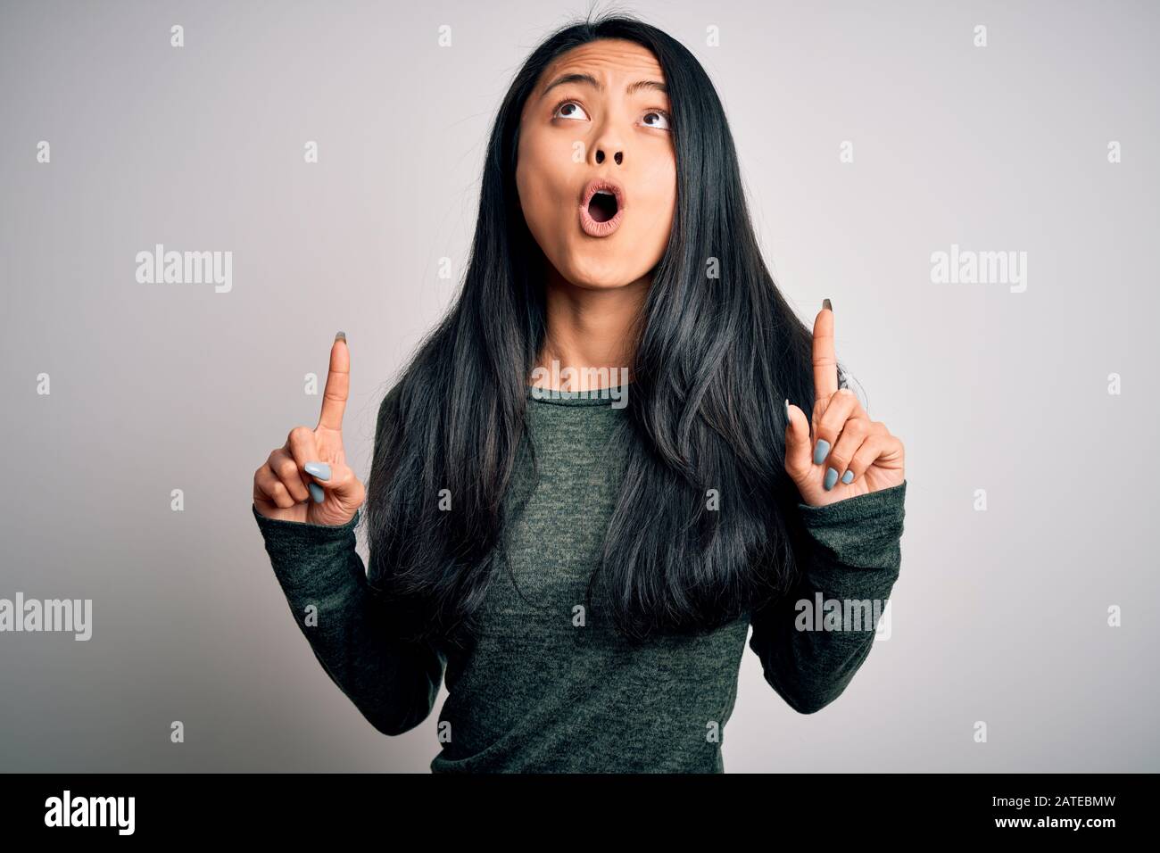 Young beautiful chinese woman wearing casual t-shirt over isolated ...