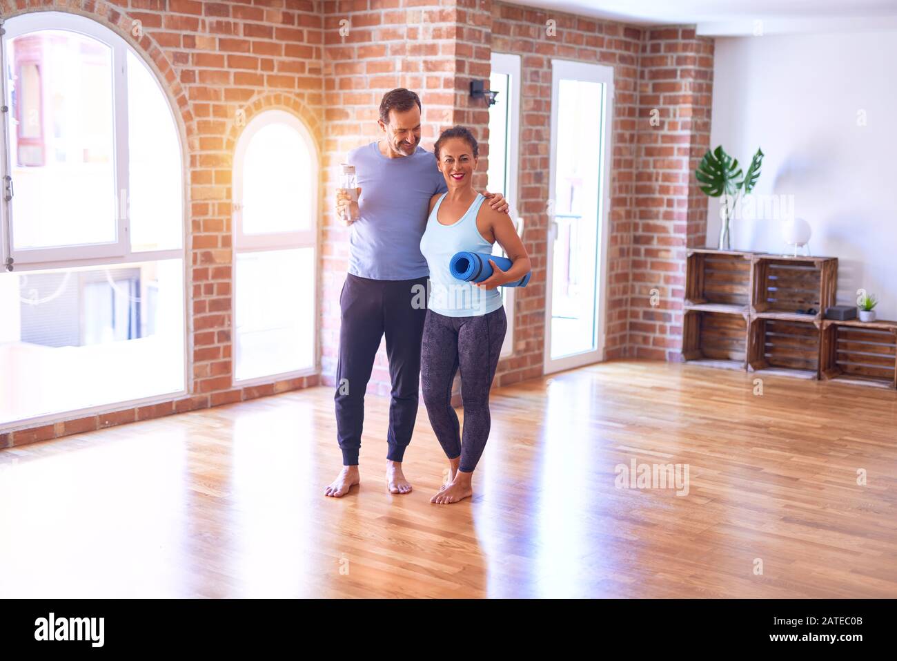Middle age beautiful sporty couple smiling happy. Standing with smile ...