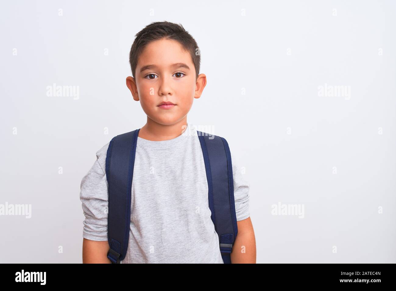 Beautiful student kid boy wearing backpack standing over isolated white ...