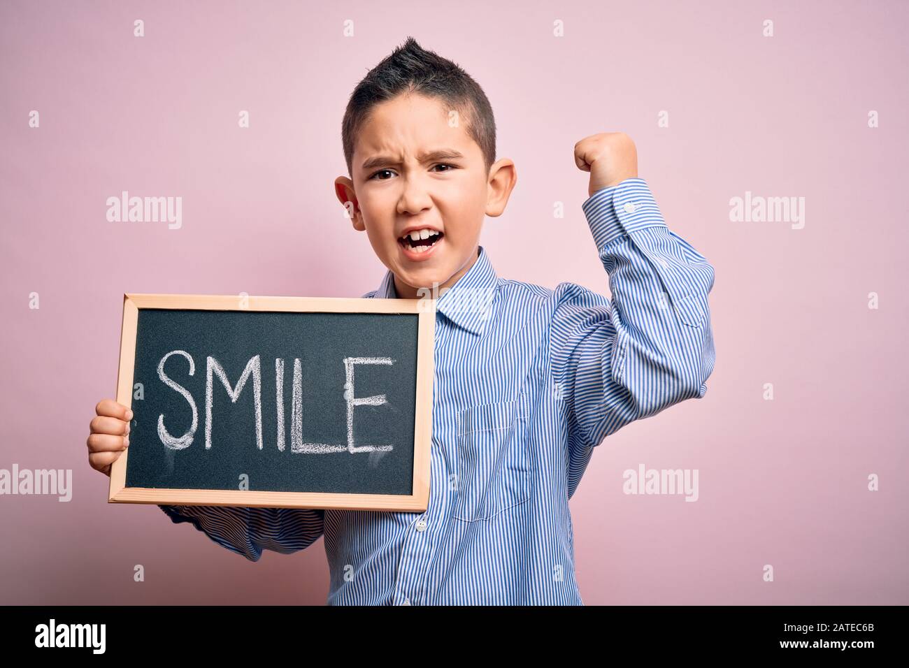 Young little boy kid showing blackboard with smile word as happy ...