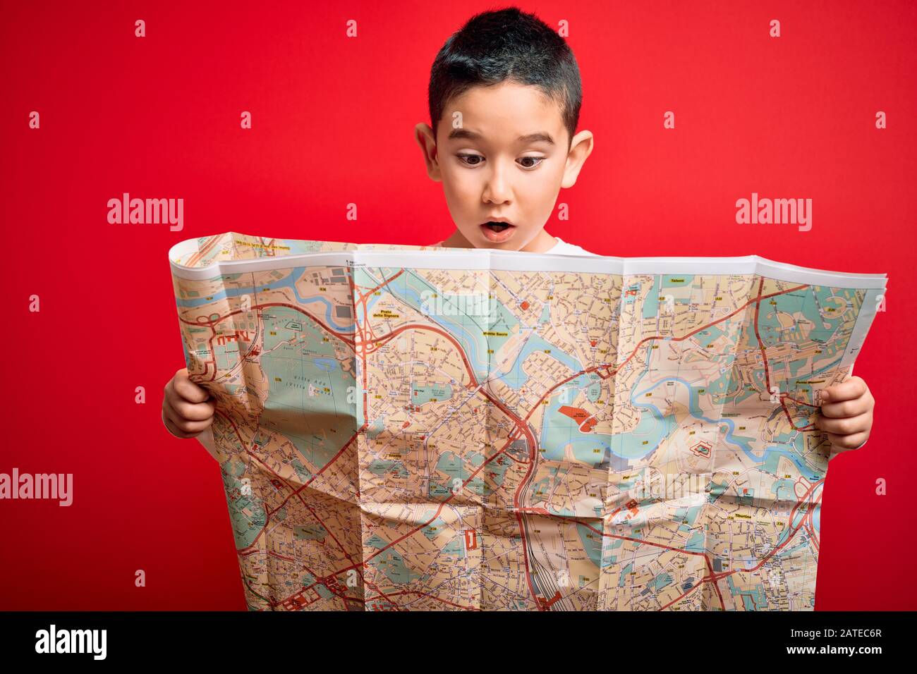 Young little boy kid looking at turist city destination map over red ...