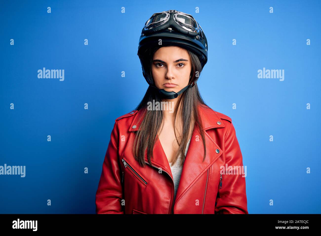 Young beautiful brunette motorcycliste woman wearing motorcycle helmet ...