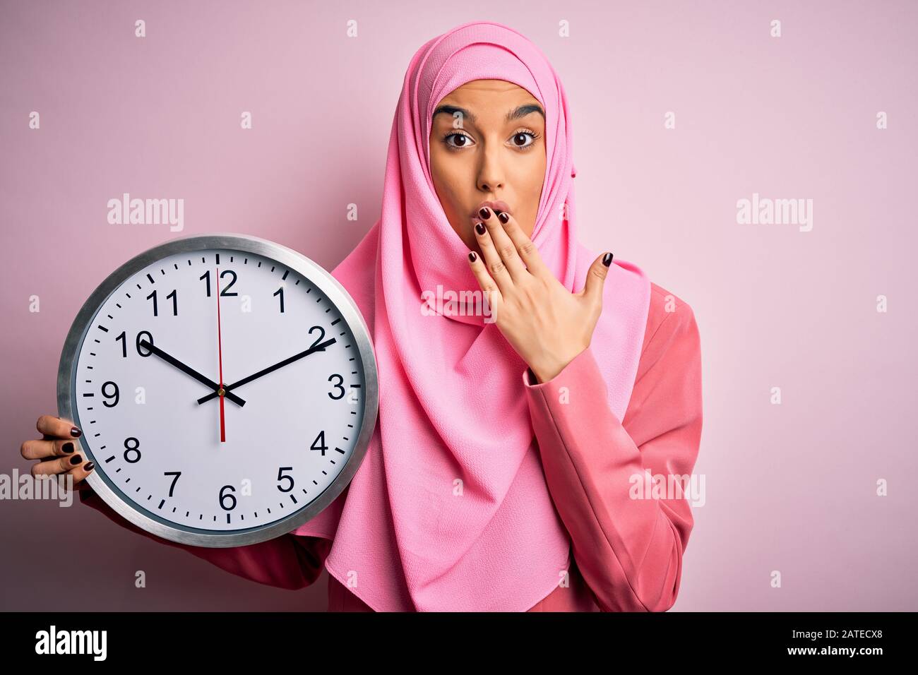 Young beautiful arab woman wearing pink muslim hijab doing countdown ...