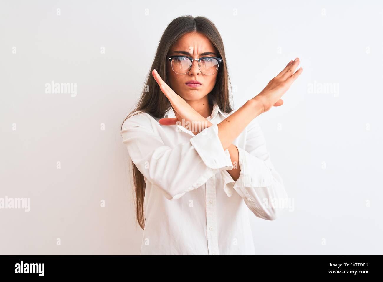 Young beautiful businesswoman wearing glasses standing over isolated ...