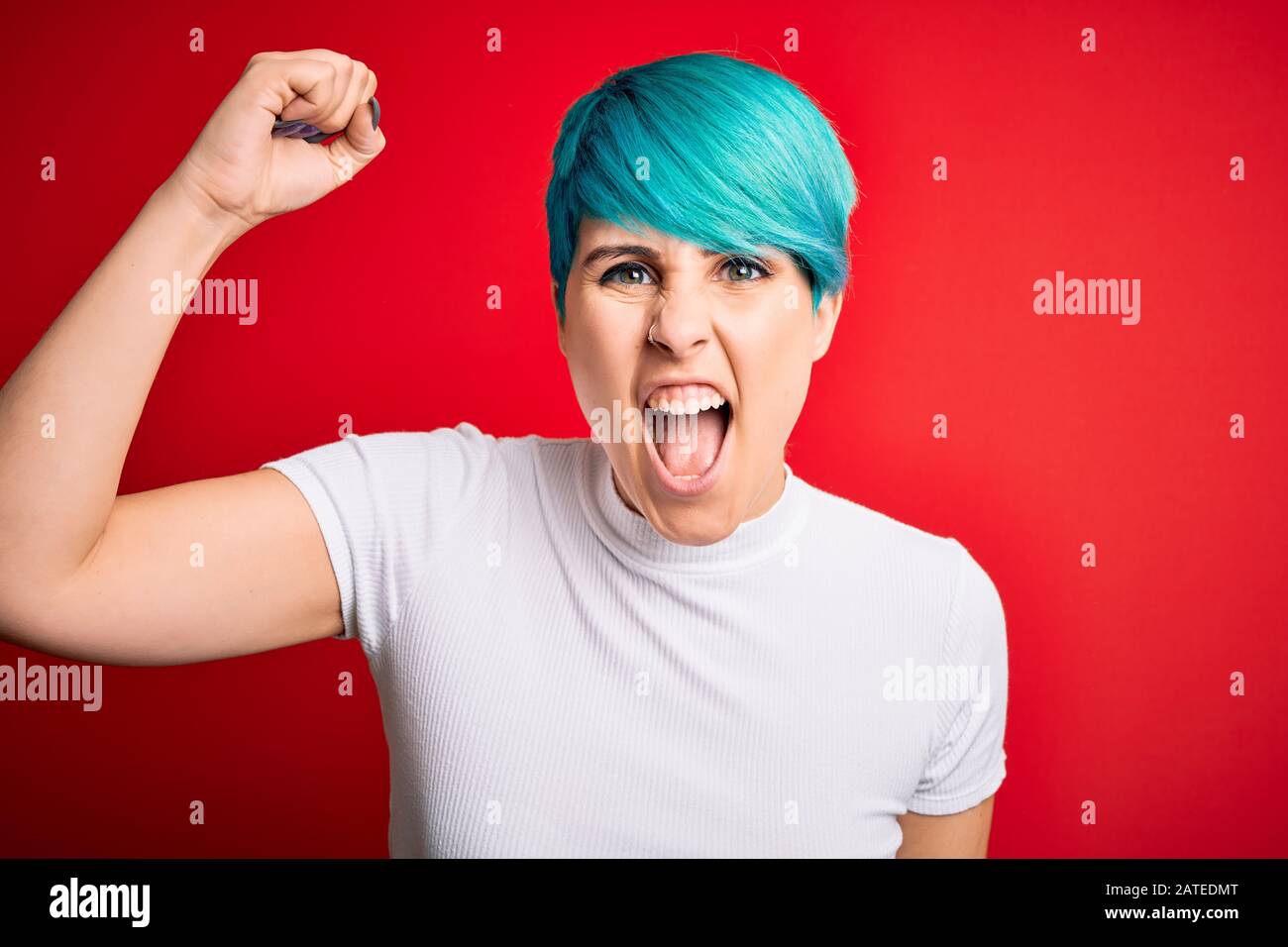 Young beautiful woman with blue fashion hair wearing casual t-shirt ...