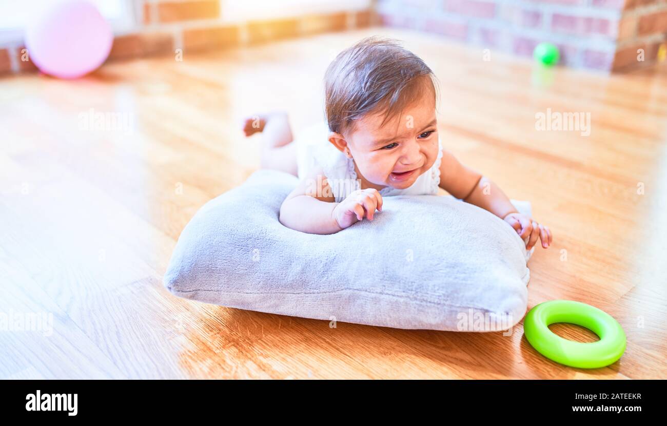 Beautiful infant happy at kindergarten around colorful toys Stock Photo ...