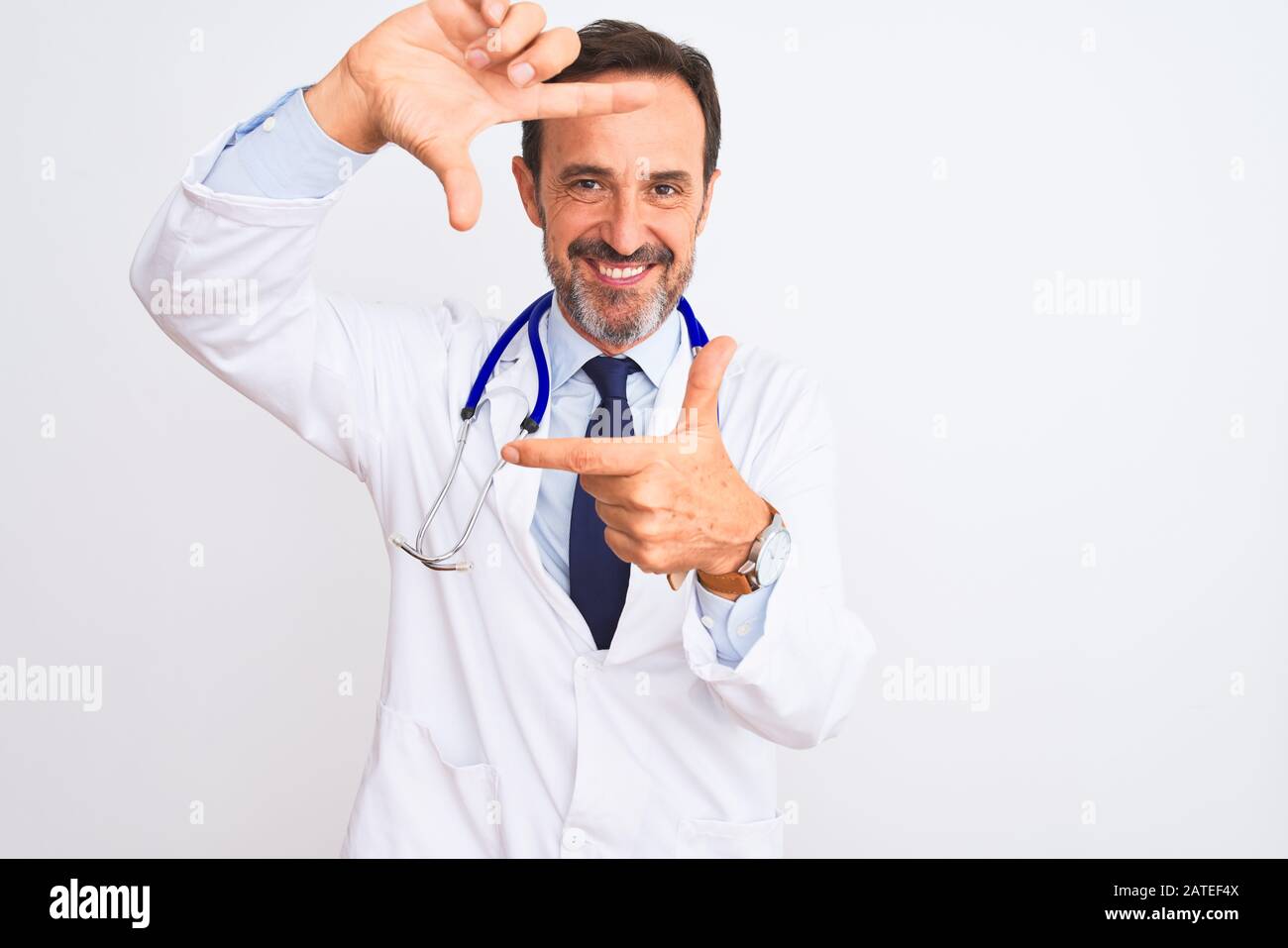Middle age doctor man wearing coat and stethoscope standing over ...