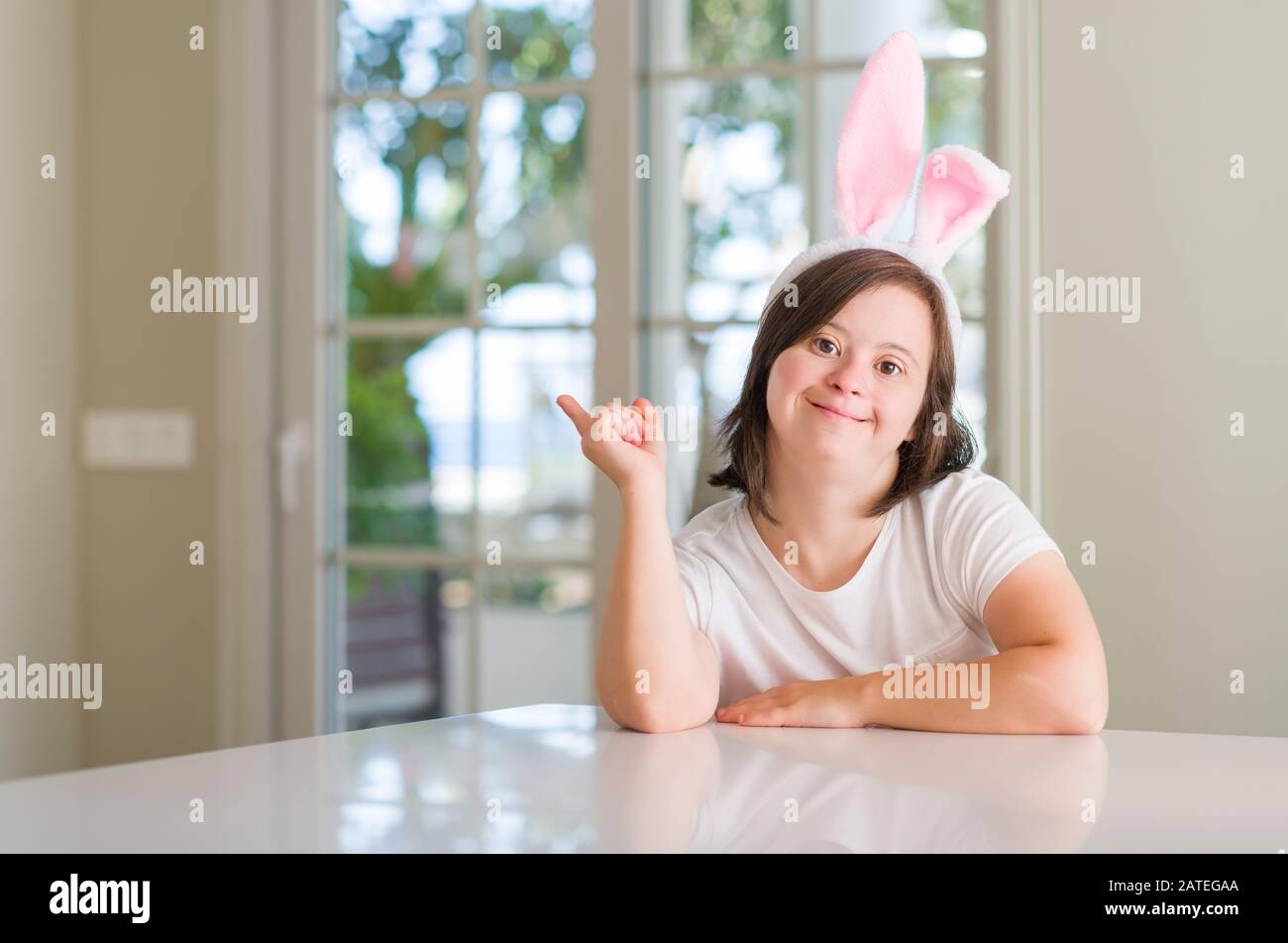 Down syndrome woman at home wearing easter rabbit ears very happy ...