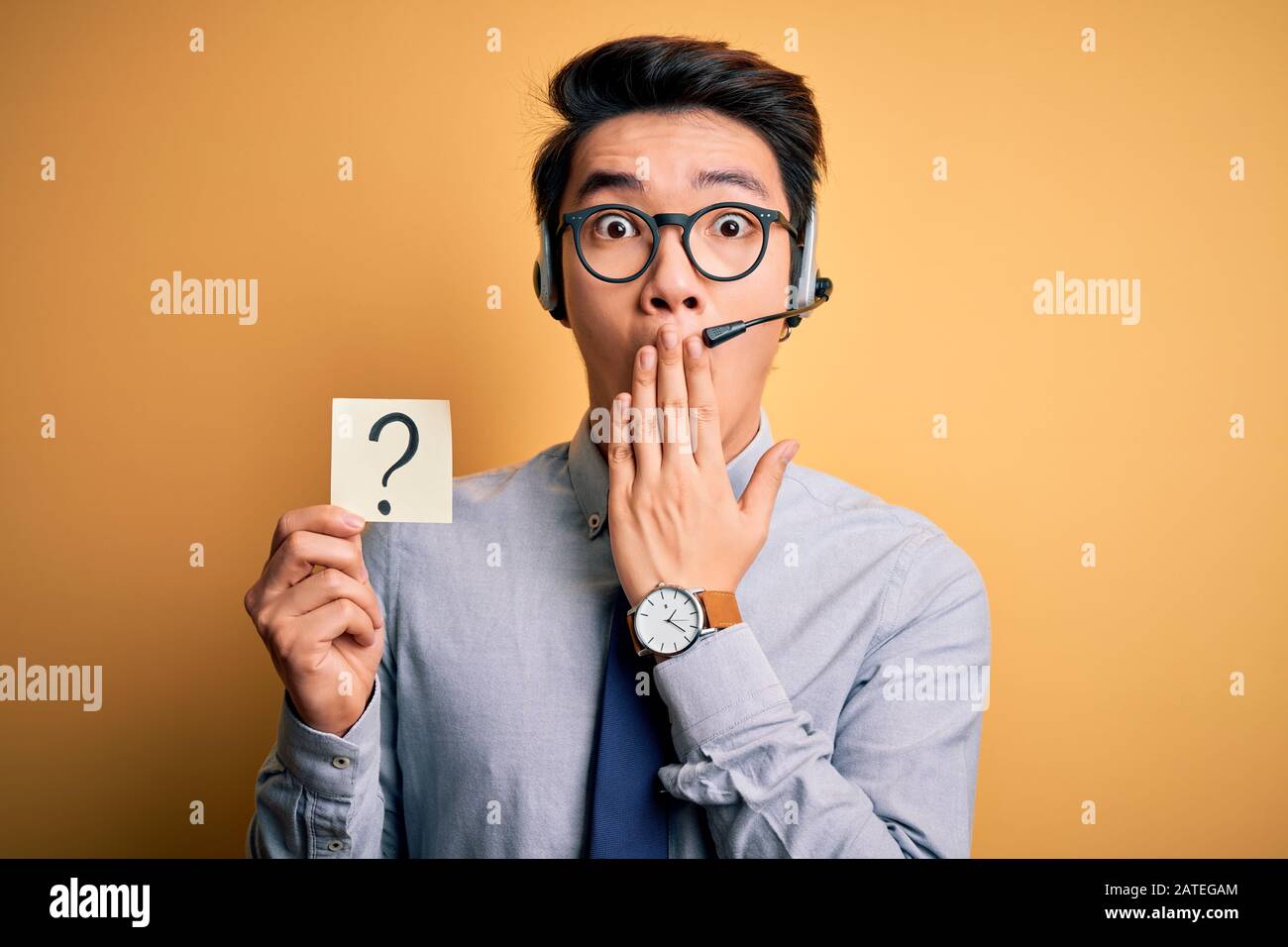 Young handsome chinese call center agent man holding paper with ...