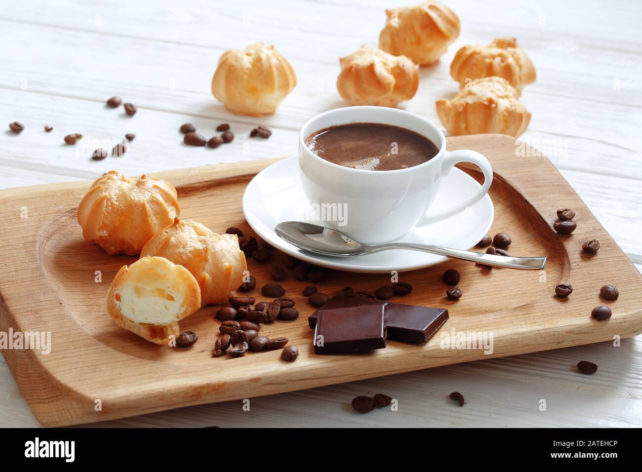Profiteroles with coffee and chocolate on a white background Stock ...