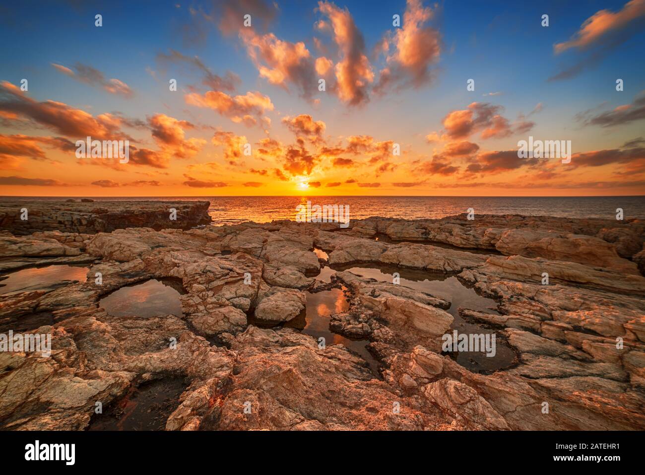 Beautiful colorful sunset near the sea at Cyprus with dramatic clouds ...