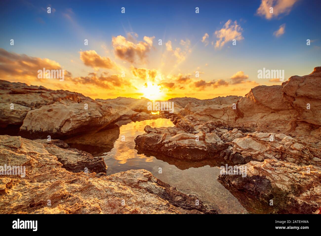Beautiful colorful sunset near the sea at Cyprus with dramatic clouds ...