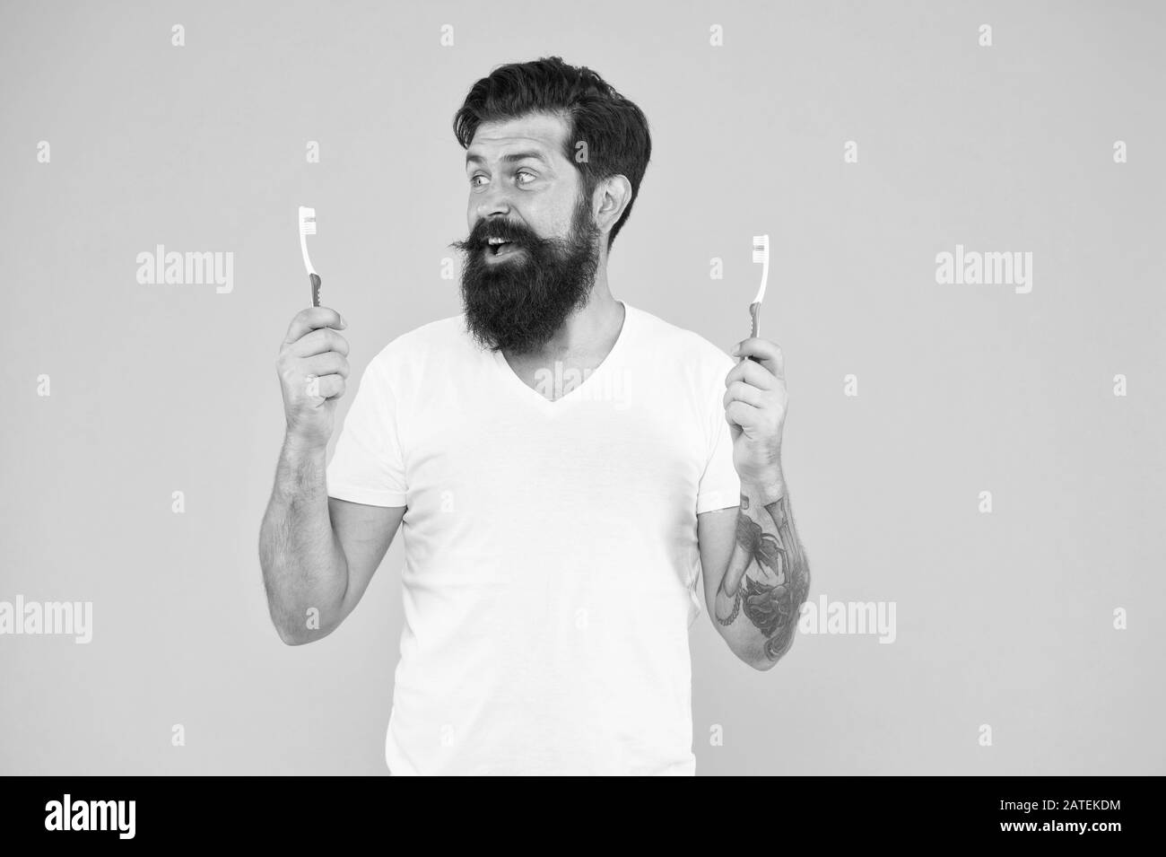 Teeth hygiene. Ultrasonic teeth cleaning technology. Bearded man holds ...