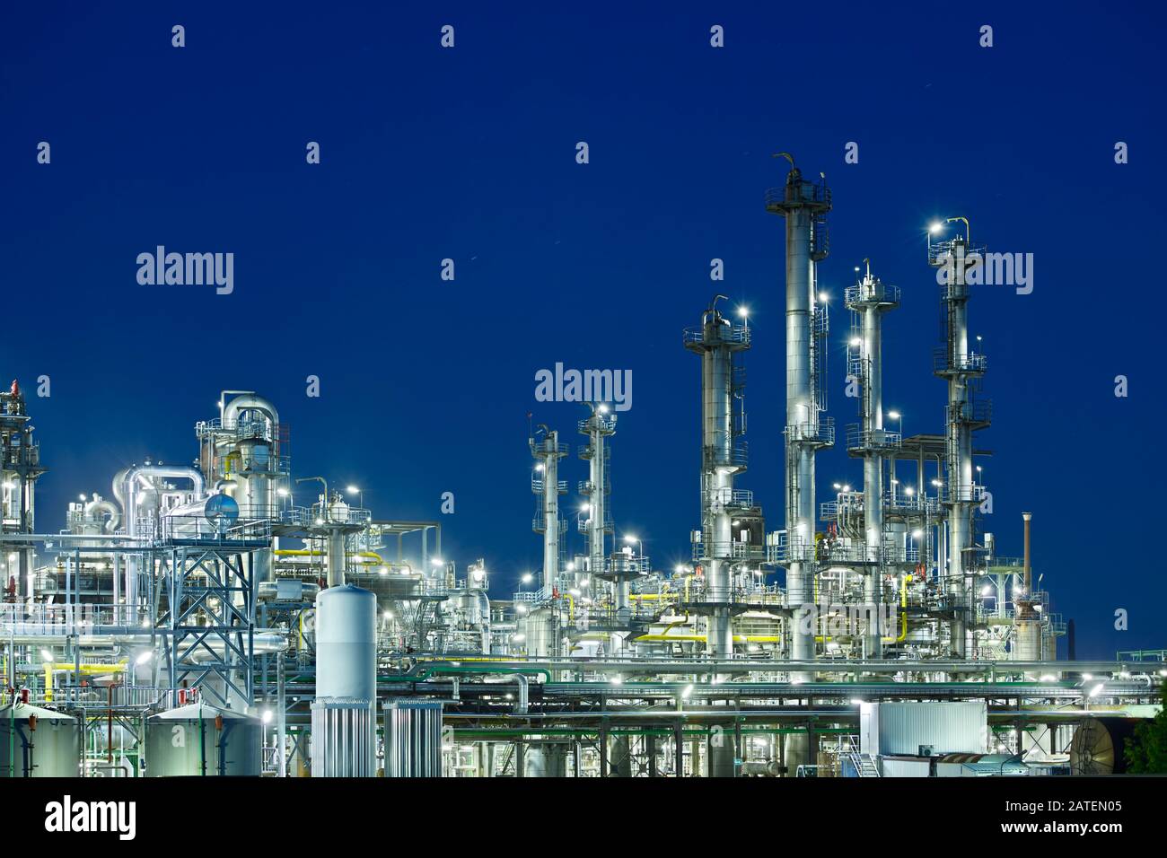 Distillation towers of a large refinery with night blue sky Stock Photo ...