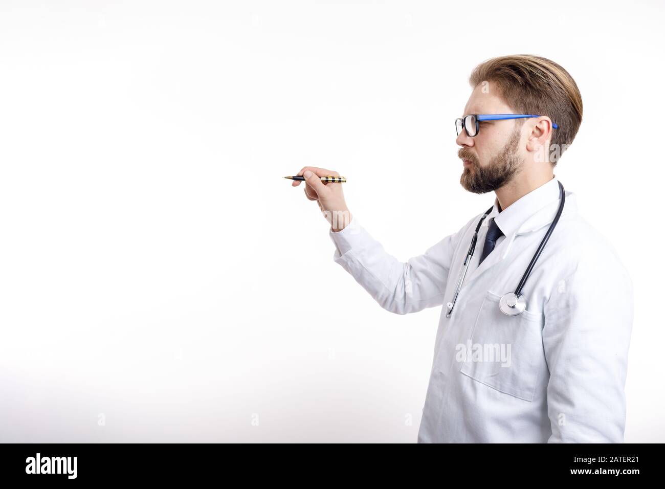 Sideview of young intelligent doctor in glasses writing in air isolated ...