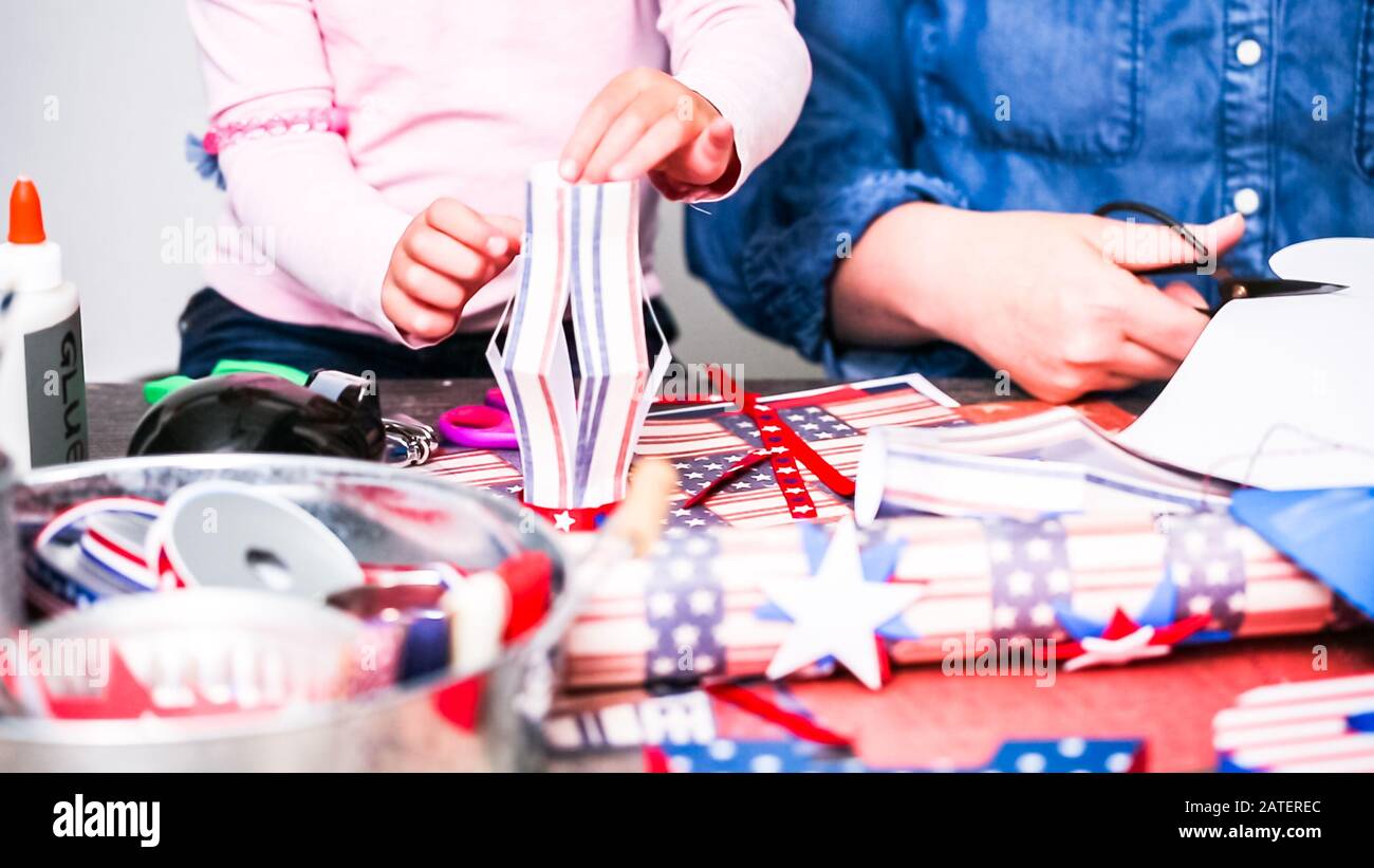 Step by step. Mother and daughter making paper firecrackers for July ...