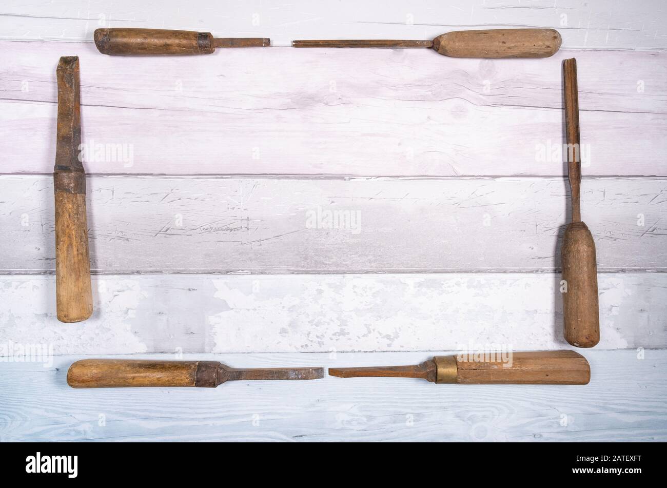 Old wood chisels forming a frame on a background of old boards. Top ...