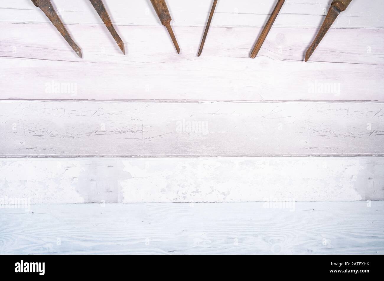 Old wood chisels forming a line at the top of a space on a background ...