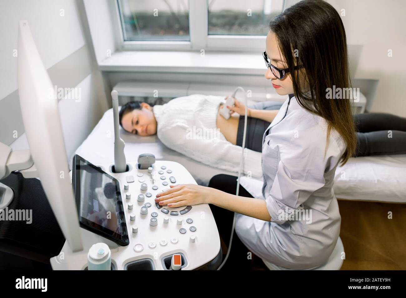 Professiona woman sonographer therapi.st working with ultrasound ...