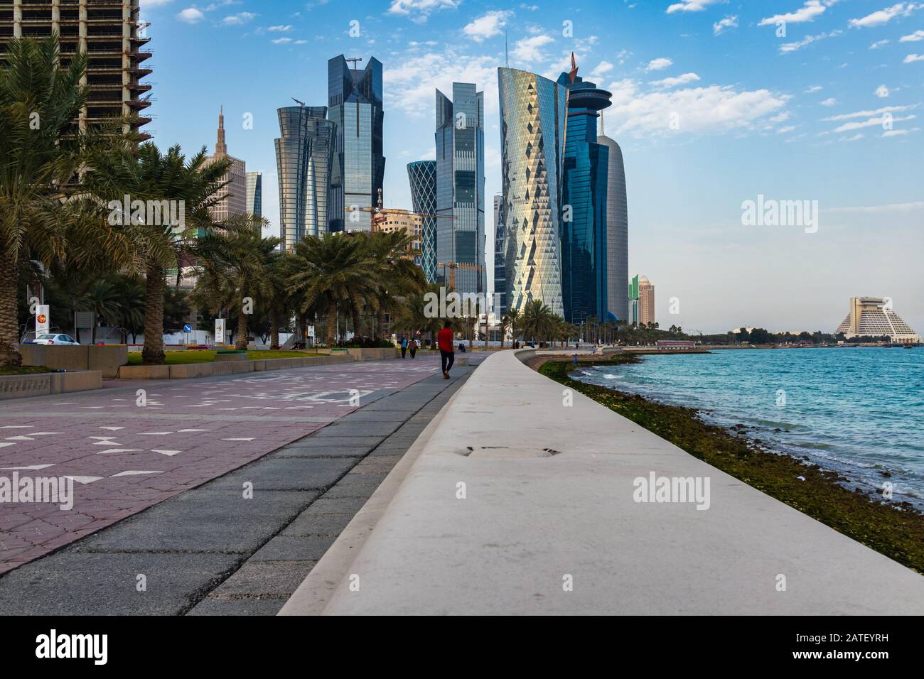 Doha corniche Daylight view with people walking, skylines and clouds in ...