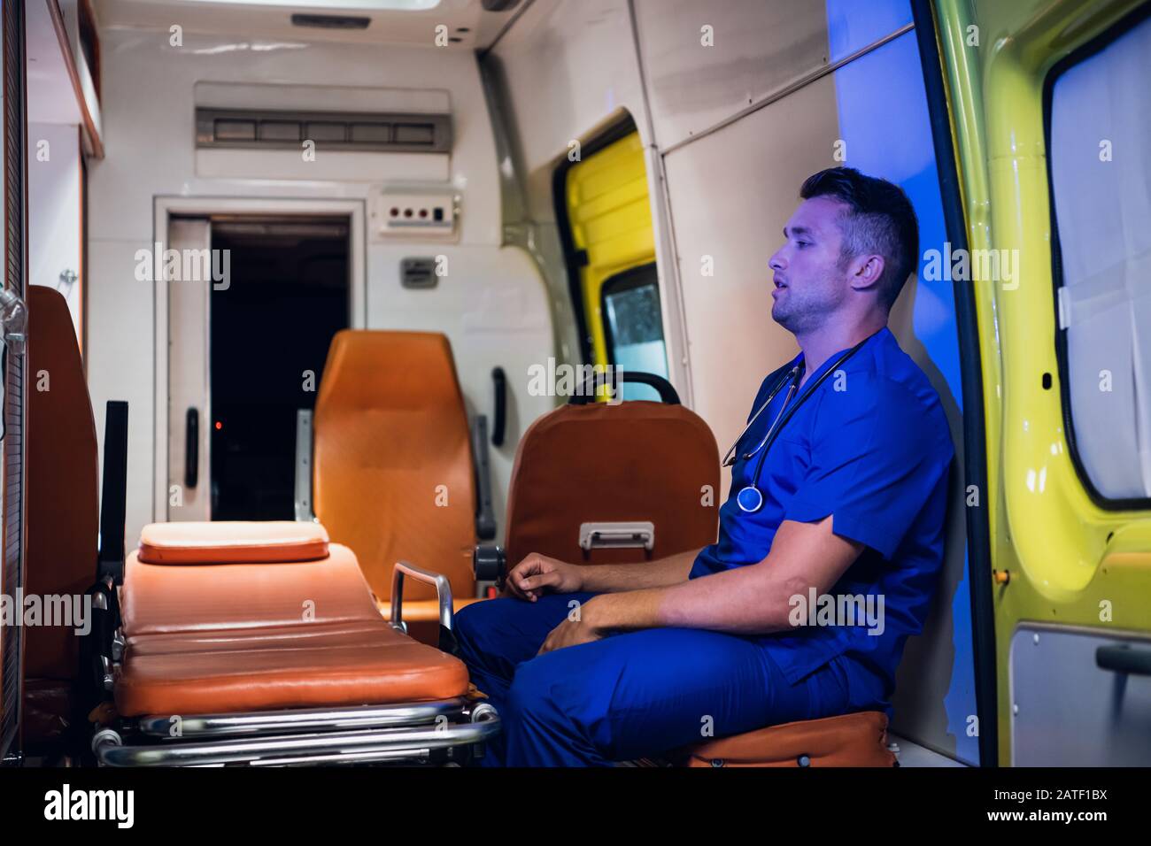 Corpsman in blue uniform sits inside the ambulance car Stock Photo - Alamy