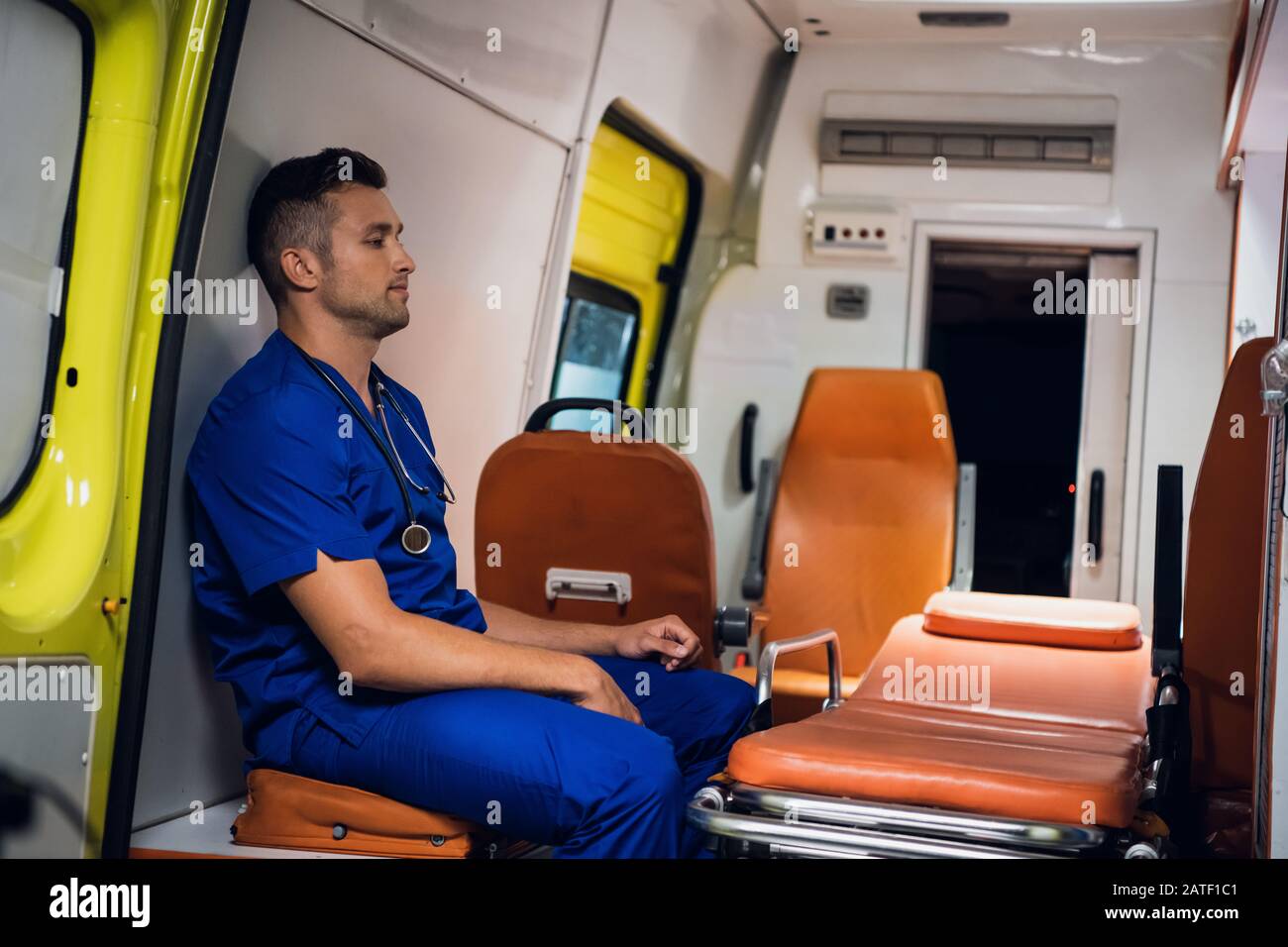 Tired corpsman in uniform sits inside the ambulance car Stock Photo - Alamy