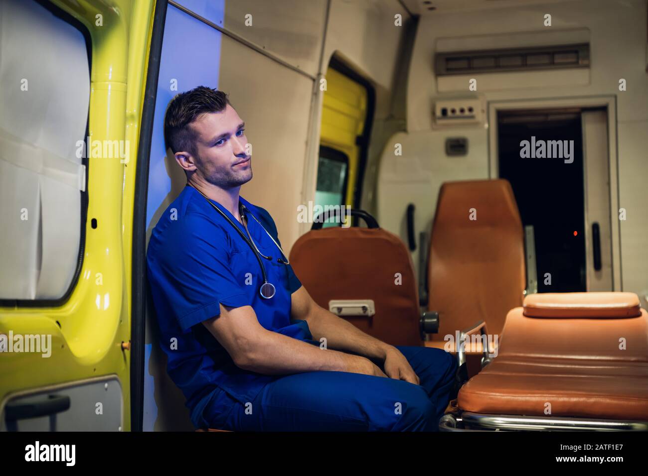 Tired corpsman in medical uniform sits inside the ambulance car Stock ...