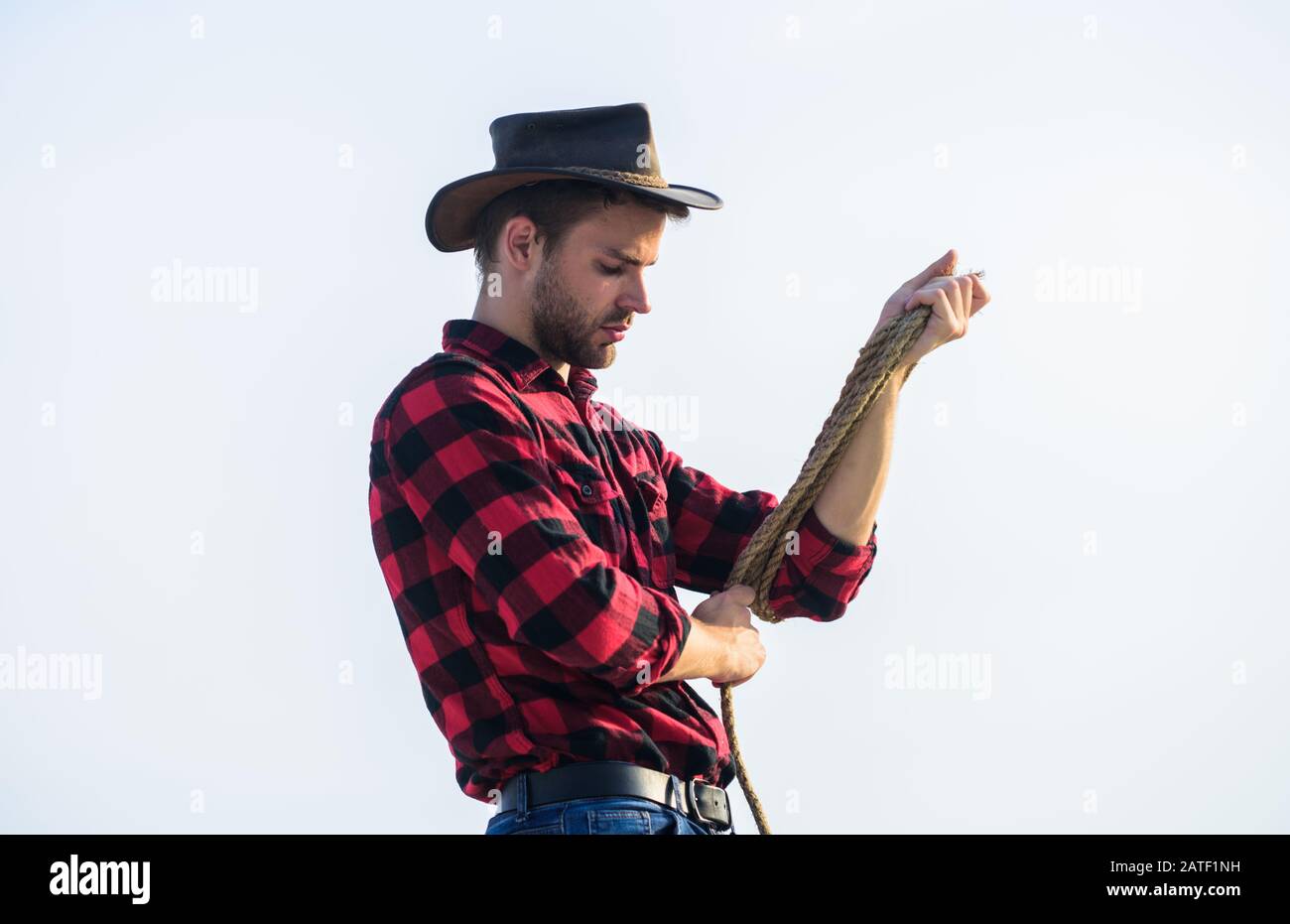 Ranch worker. Eco farm. Farming concept. Handsome man in hat and rustic ...