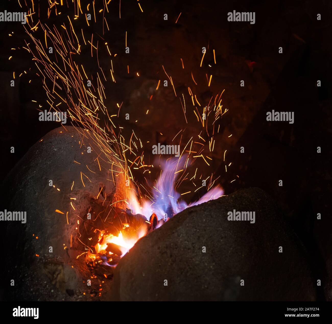 Smithy fire flame tips with sparks closeup on dark background Stock ...