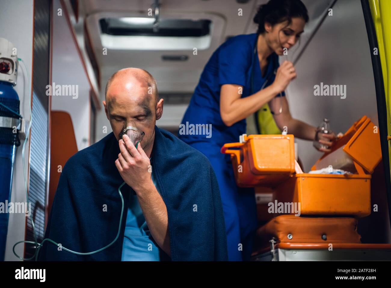 Man breathe through oxygen mask, nurse in medical uniform opens ...
