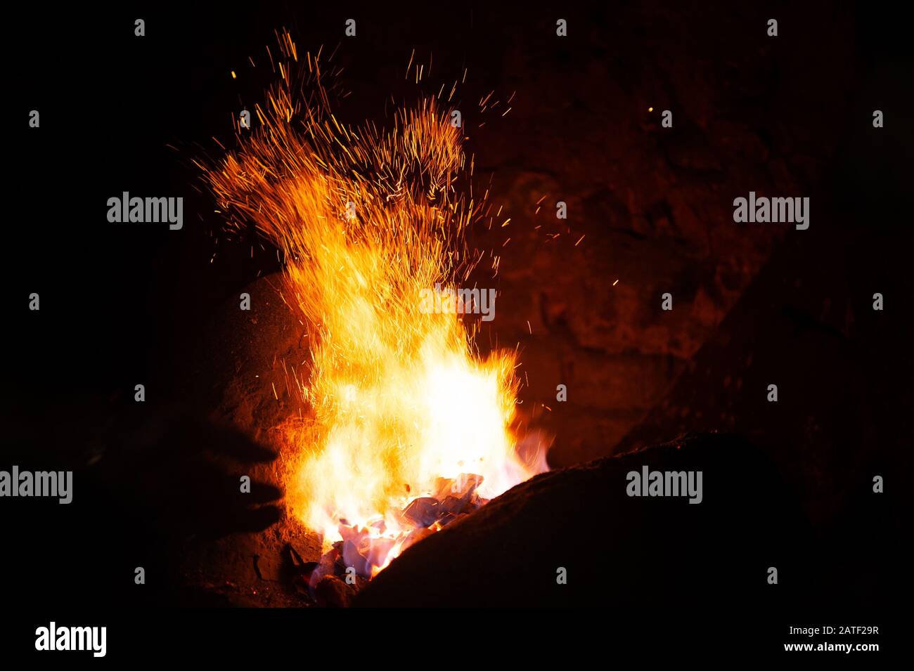 Smithy fire flame tips with sparks closeup on dark background Stock ...