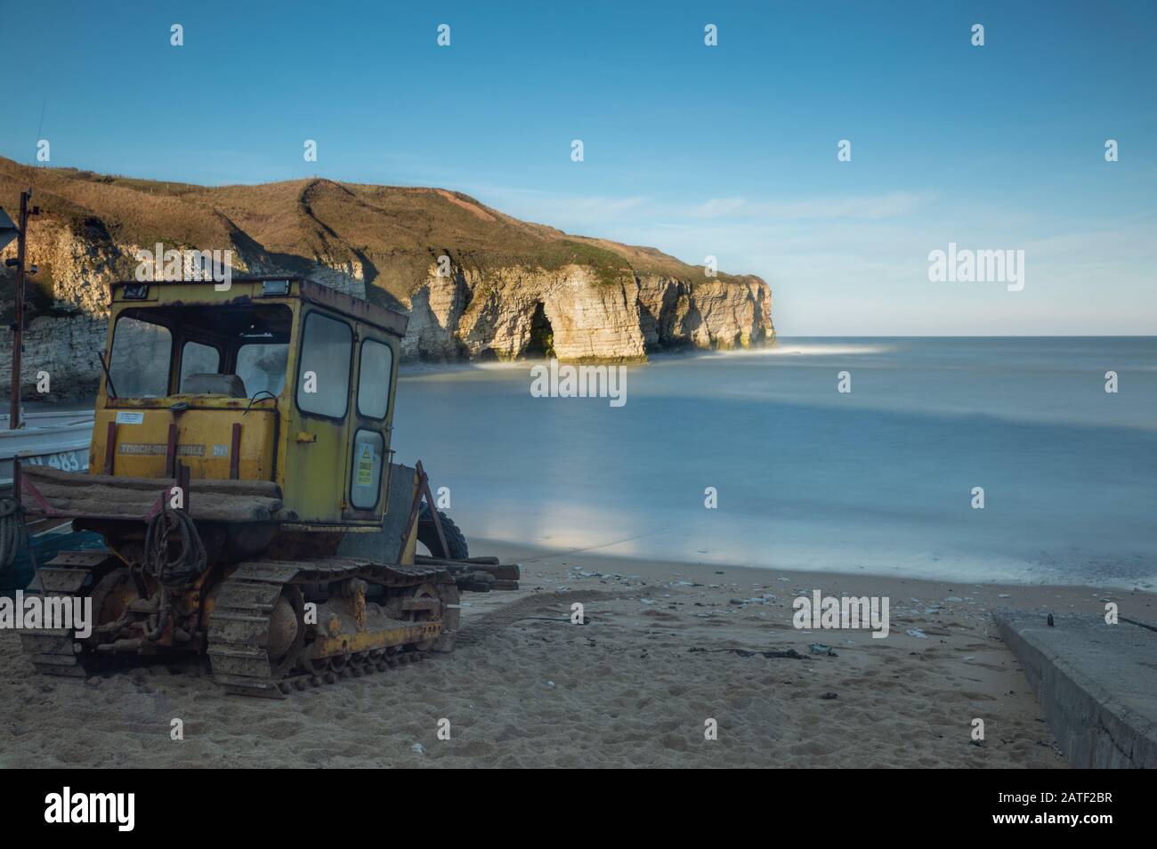 A Tractor parked on the North Landing Beach at Flamborough as the Tide ...