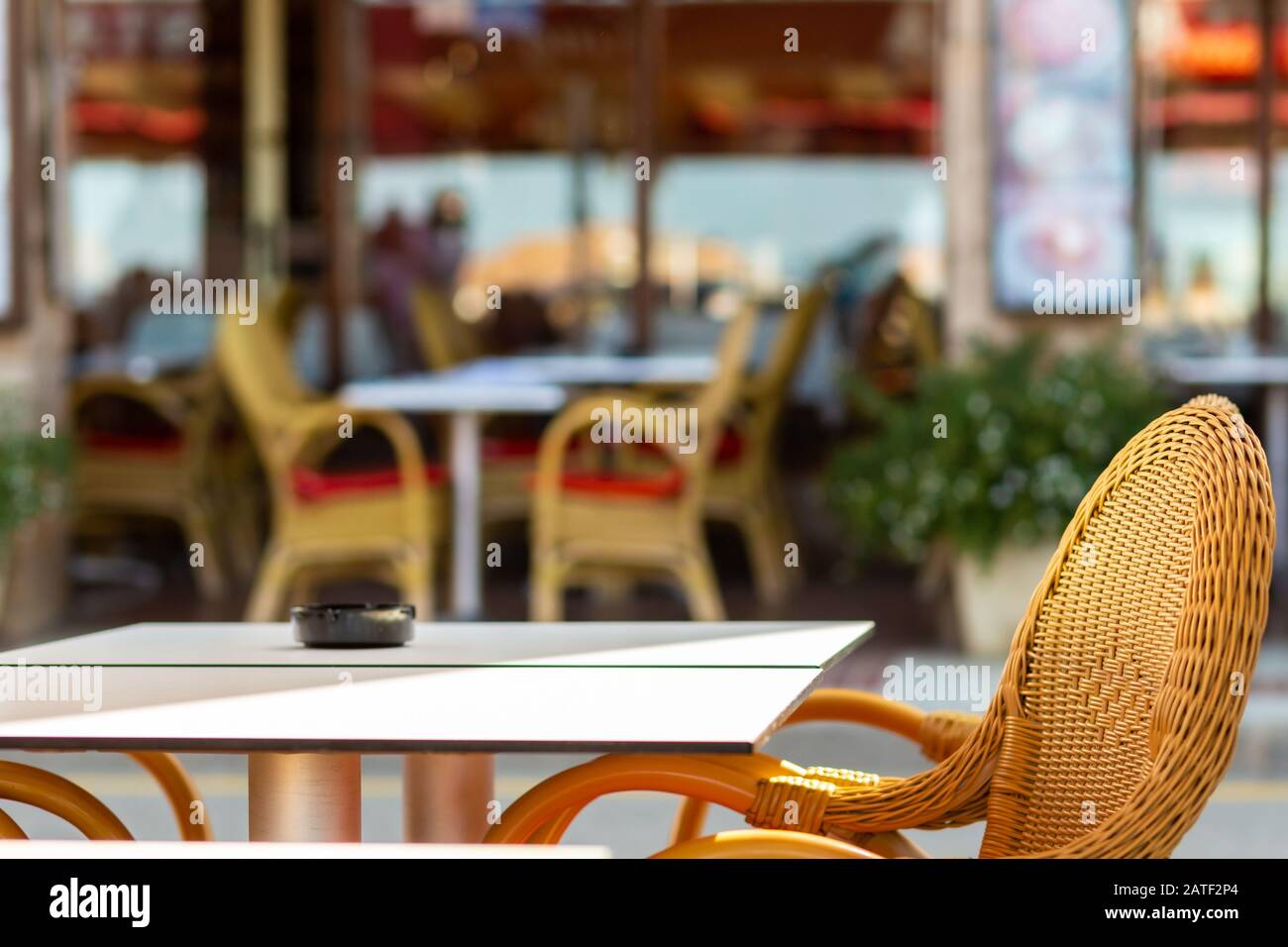 A street summer cafe with wicker chairs Stock Photo - Alamy