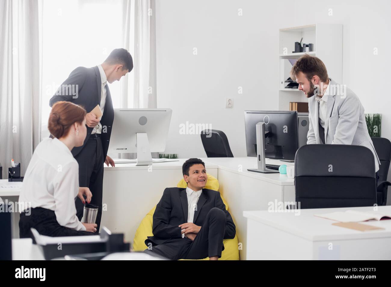Young office workers have a break time and talk during working day in ...