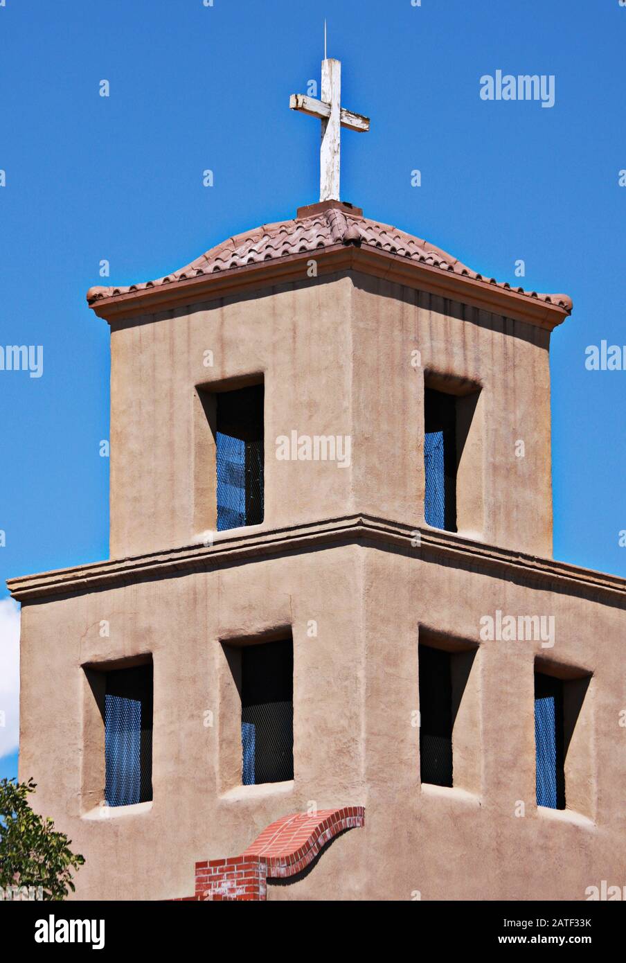 Bell tower of Our Lady of Guadalupe Church, with white wooden cross ...