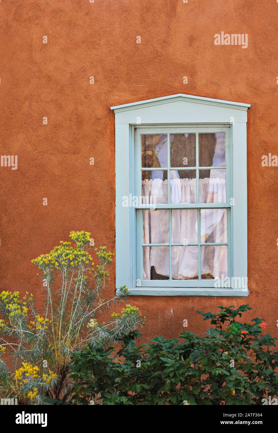 Blue wooden window in adobe building. Pueblo adobe plaster architecture ...