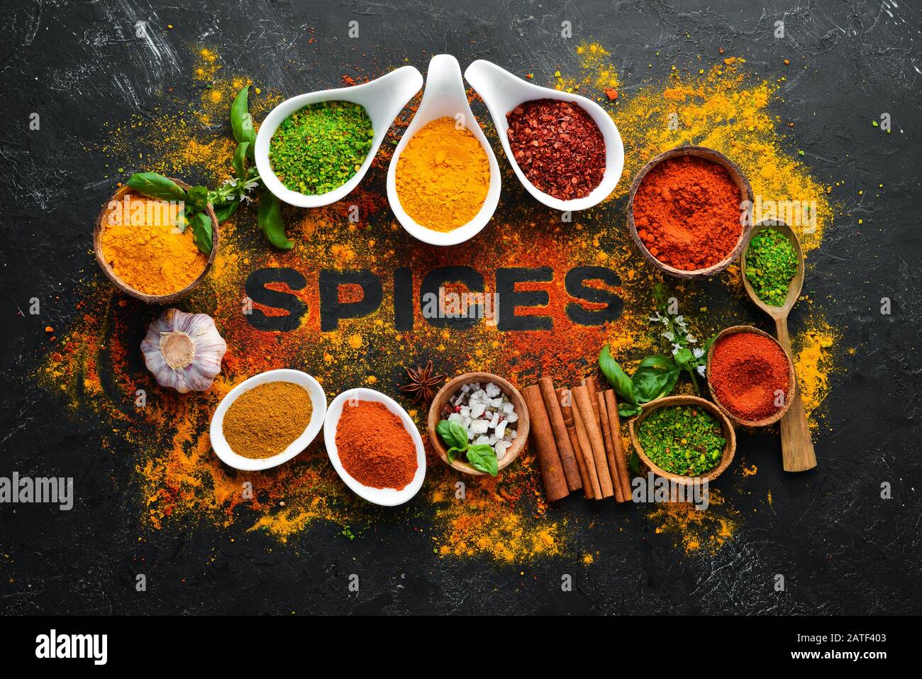 Indian spices on a black stone background. The word "spice" Indian ...