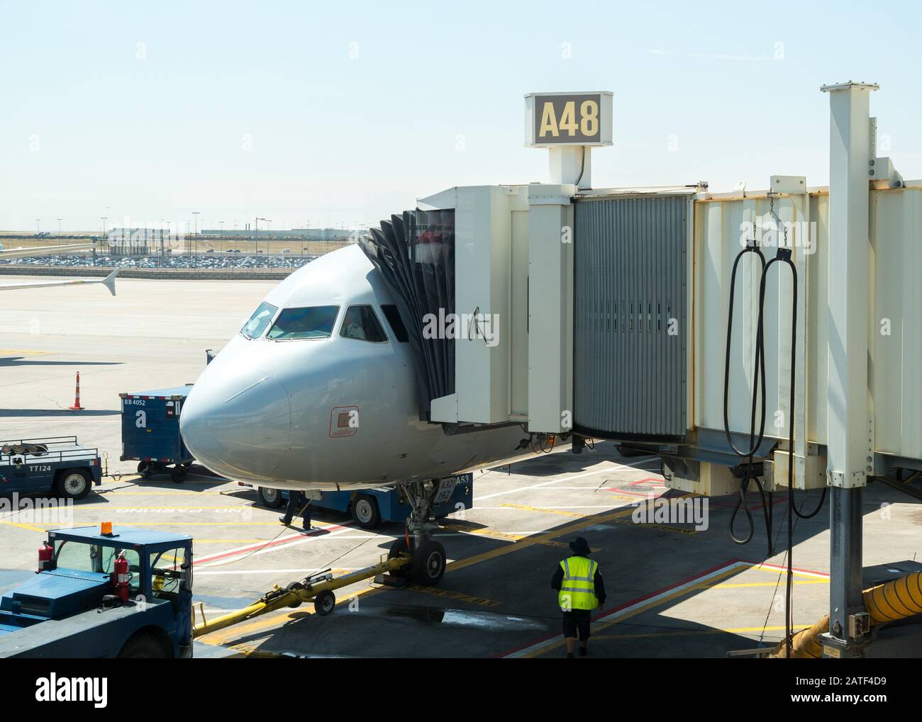 Plane docked at airport terminal connected with passenger boarding ...