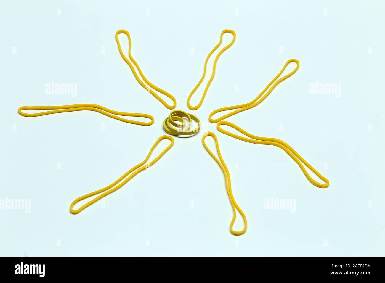 Yellow sun from colored rubber bands on a white background Stock Photo ...