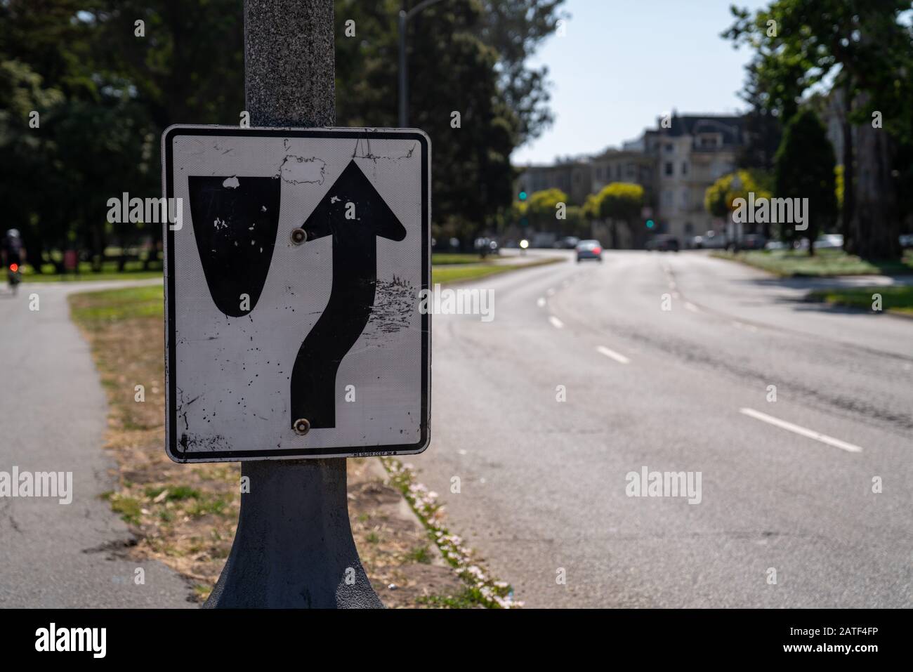 Rounded curve corner warning sign on light post at city street Stock ...